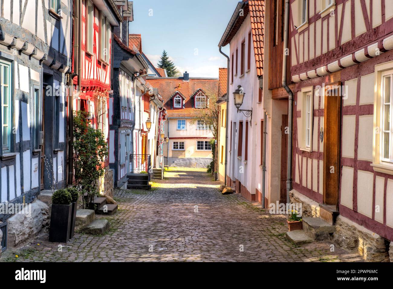 Paved street with renovated half-timbered houses on the edge in the ...