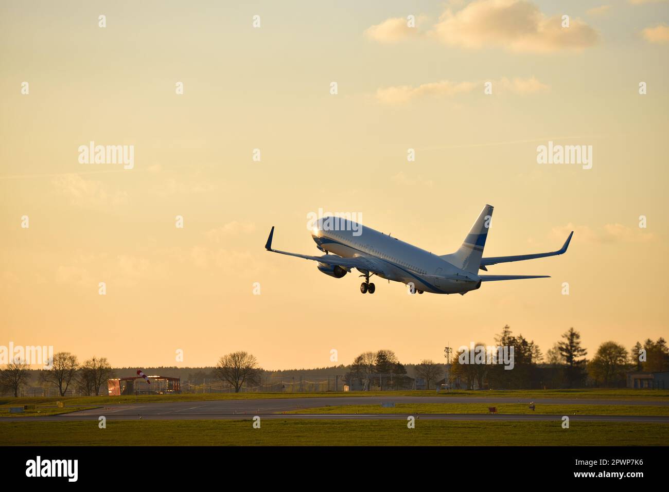 The plane takes off during sunset Stock Photo - Alamy