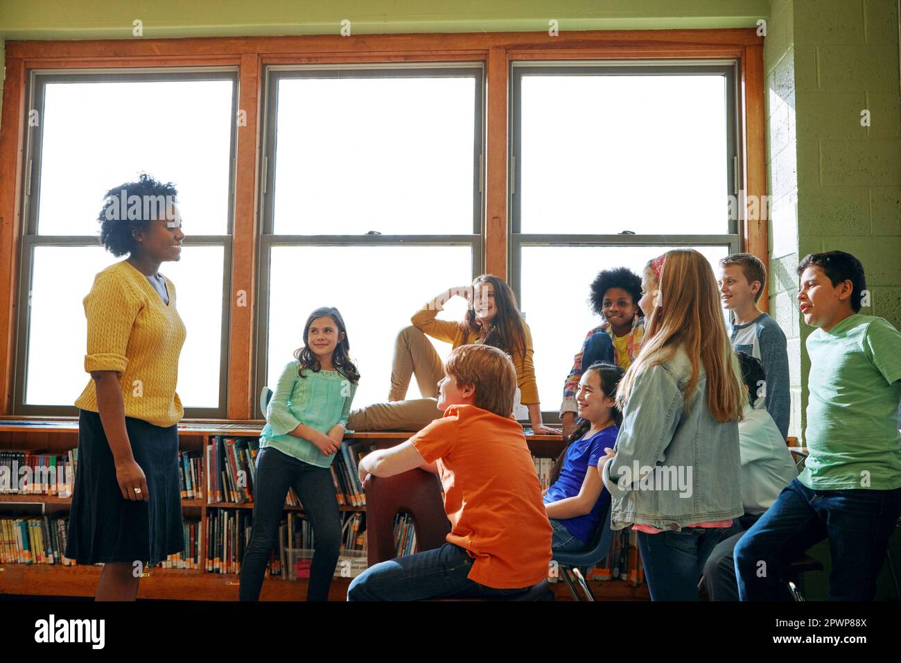 Stimulating young minds. a young teacher educating a group of elementary children Stock Photo ...