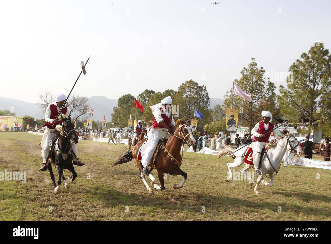 Islamabad. 30th Apr, 2023. Horse riders compete during a tent pegging ...