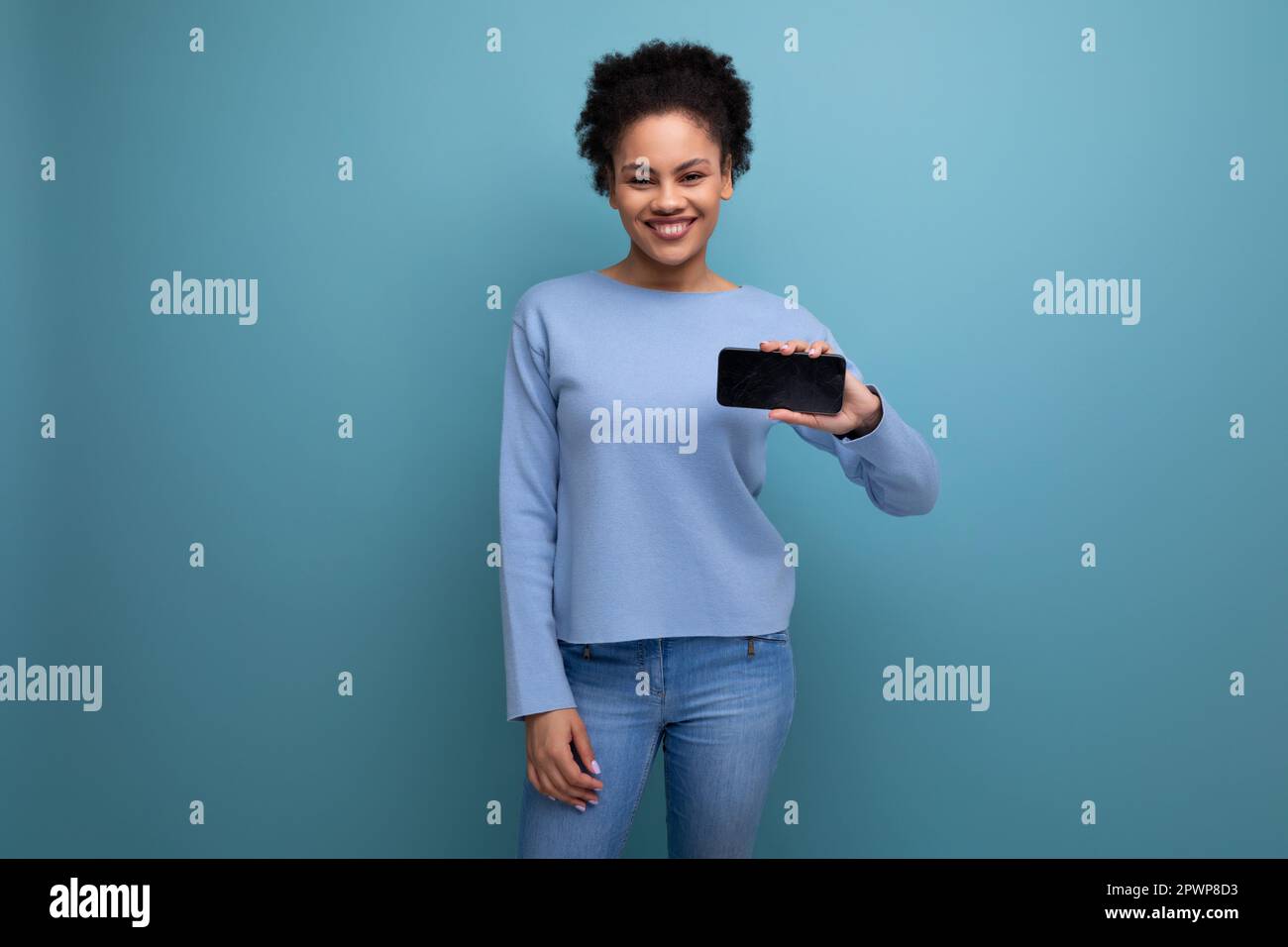 young brunette swarthy skin woman holding smartphone horizontally with ...