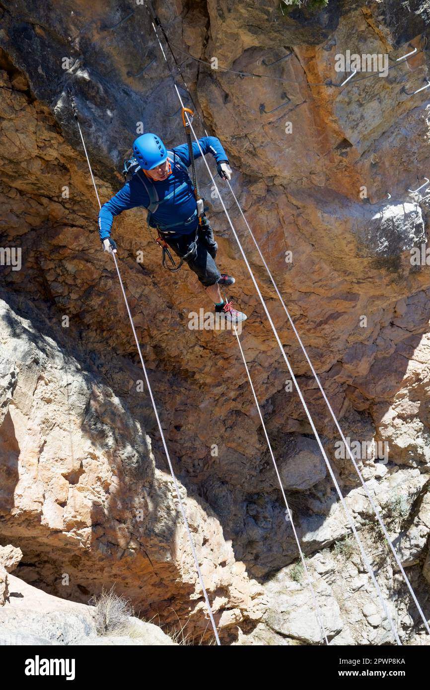 Climbing a ferrata route in San Blas, Arquillo reservoir in Teruel ...