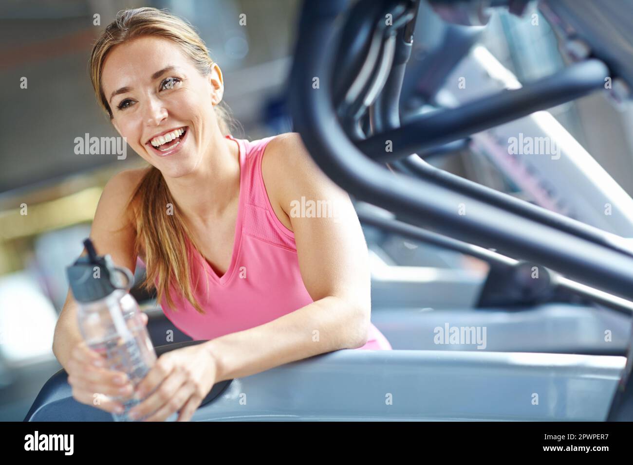Taking a quick break between workouts. A young woman resting after her ...