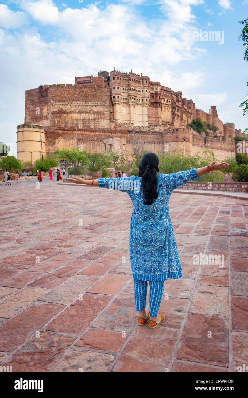 girl standing shot with ancient fort background at day from flat angle ...