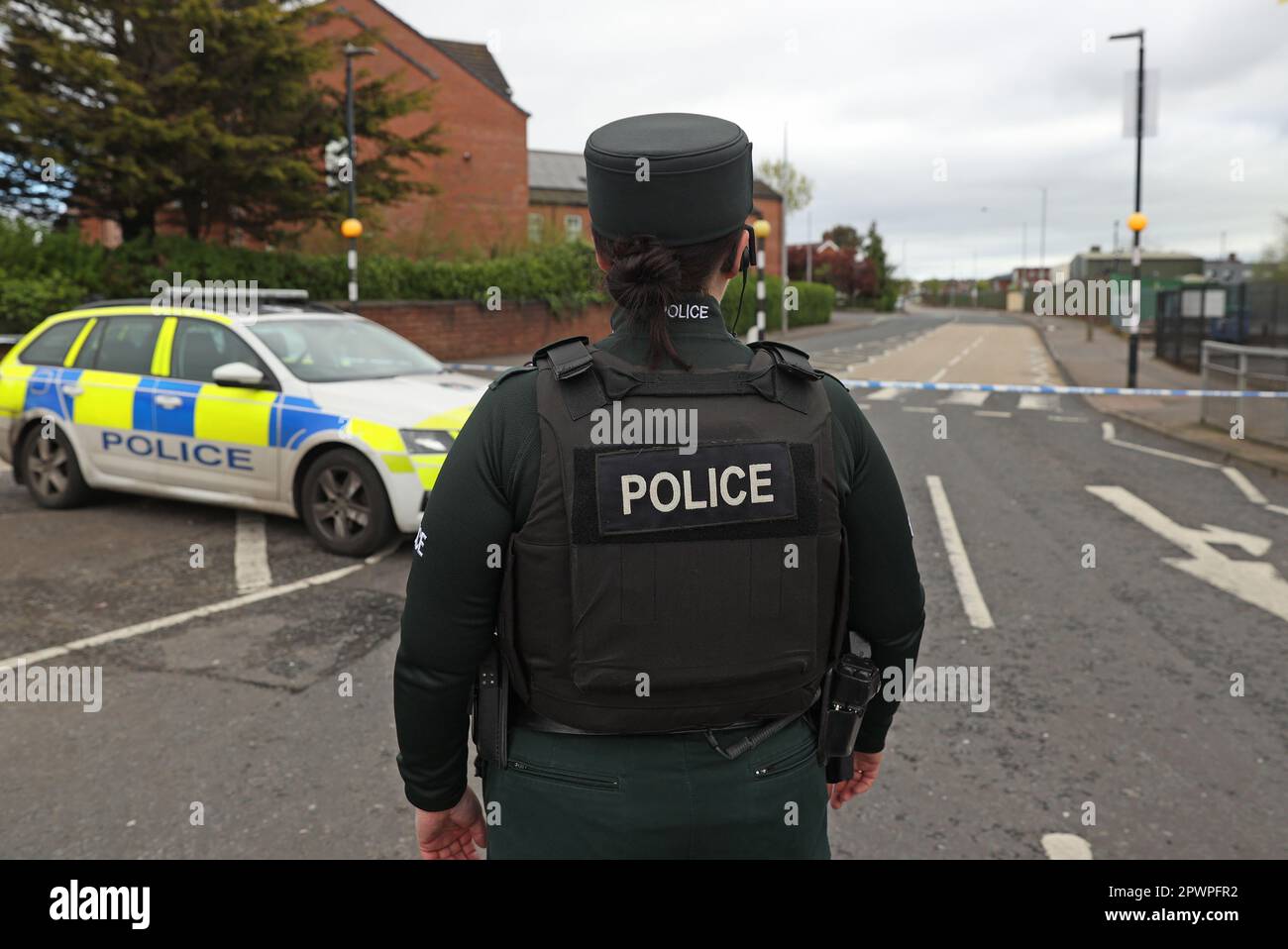 A PSNI officer on Ladas Drive in Belfast as a man has been arrested ...