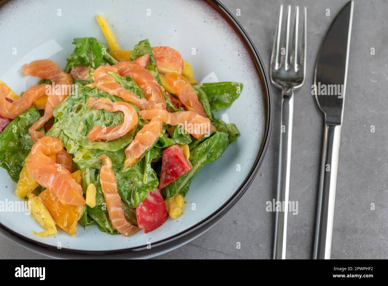 Salmon salad on stone table in fine dining restaurant Stock Photo - Alamy