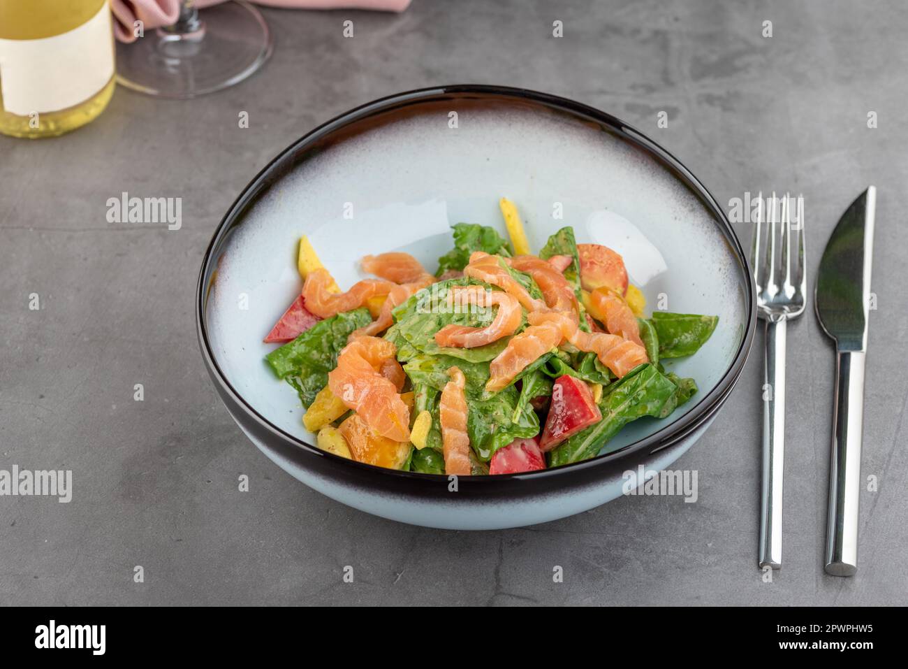 Salmon salad on stone table in fine dining restaurant Stock Photo - Alamy