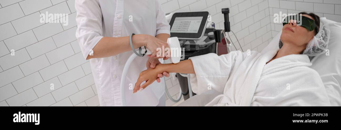 Woman getting hair removing procedure on hands. Laser epilation and ...