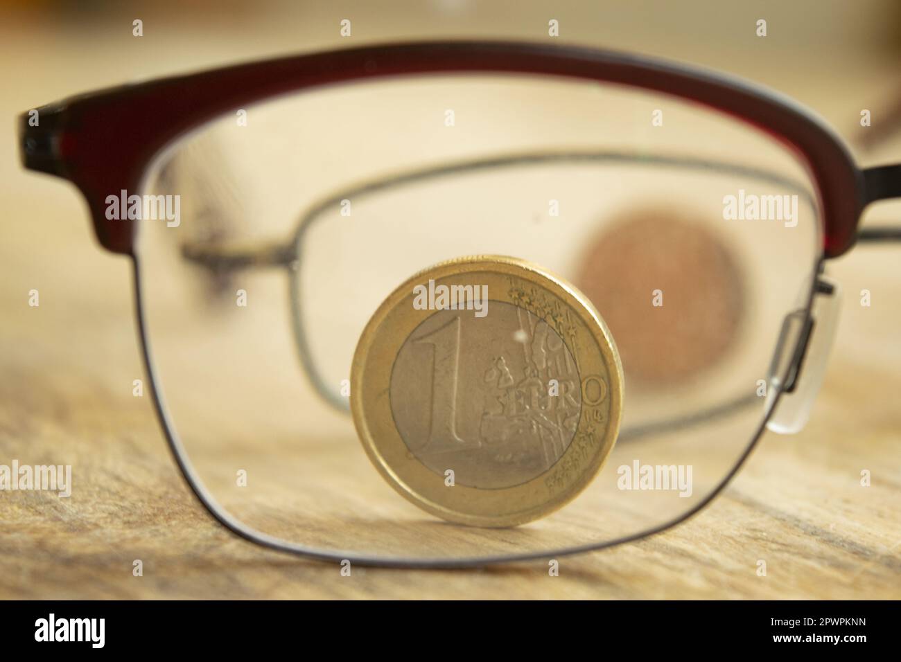 coins of various value seen through the lenses of 2 glasses Stock Photo ...