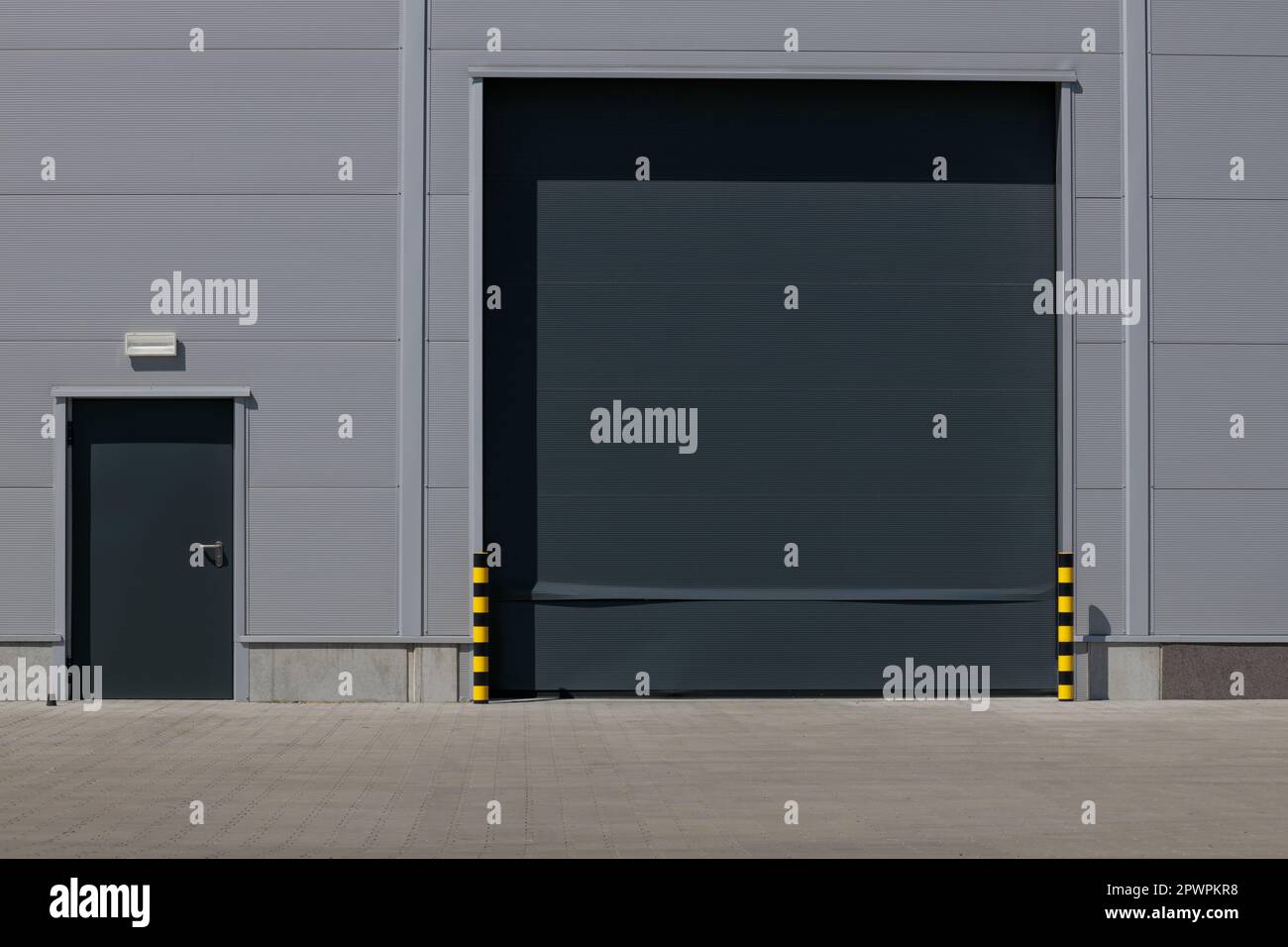 Roller shutter entrance to industrial loading area Stock Photo - Alamy