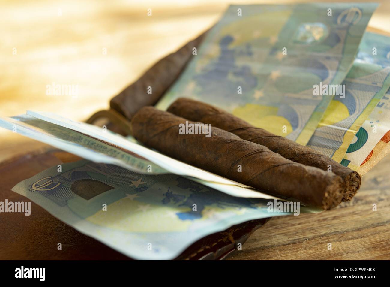 smoking costs concept with cigars leaning on banknotes Stock Photo - Alamy