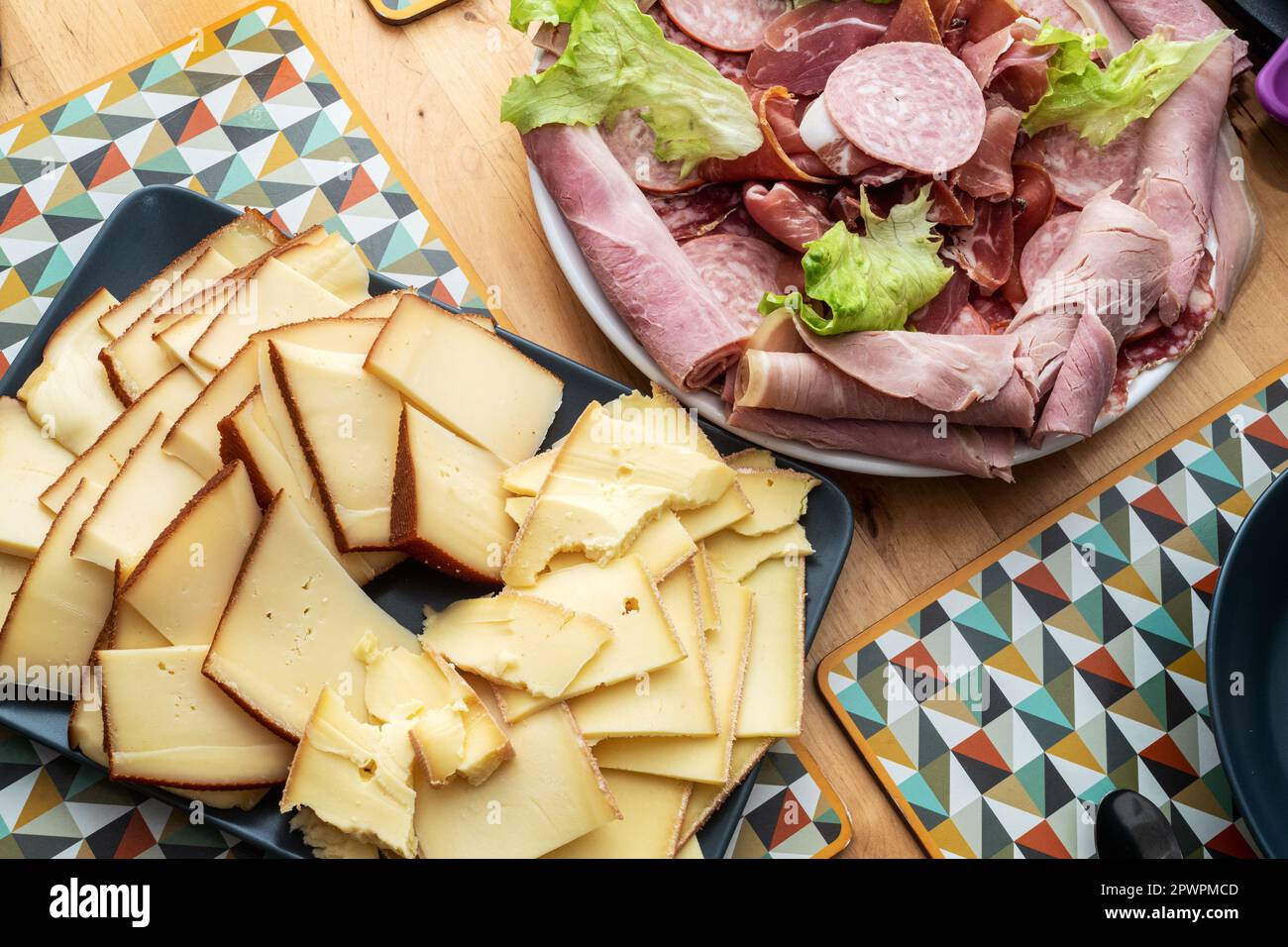 Raclette cheese and meat, a french tradition Stock Photo - Alamy