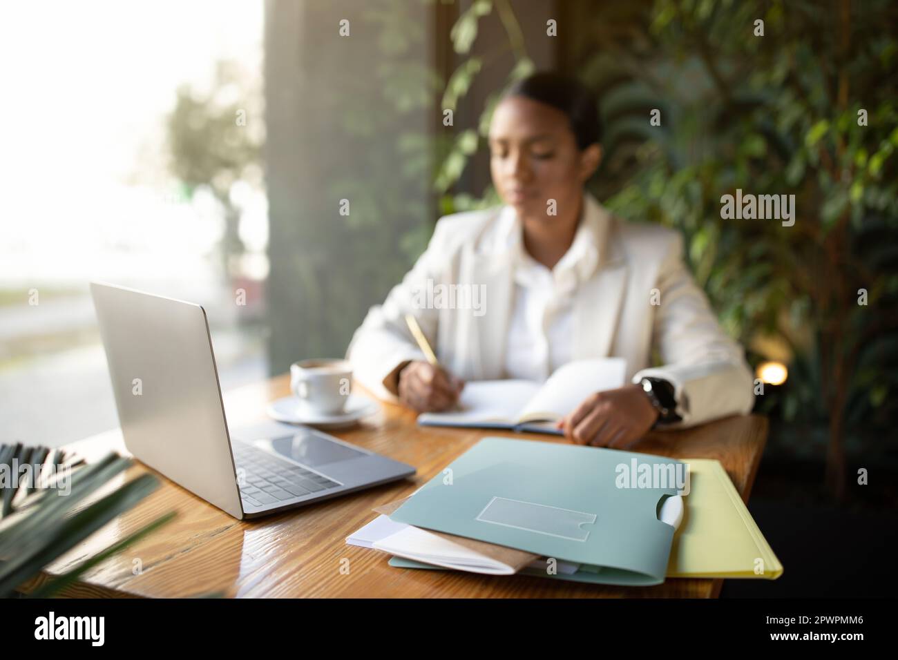 Modern restaurant business. Busy young black woman in white suit at ...