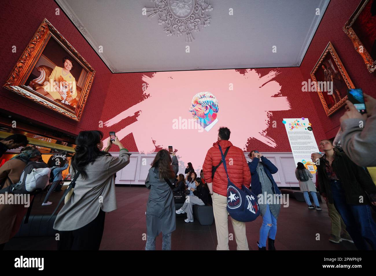 A digital portrait of King Charles III is unveiled on the screens at ...
