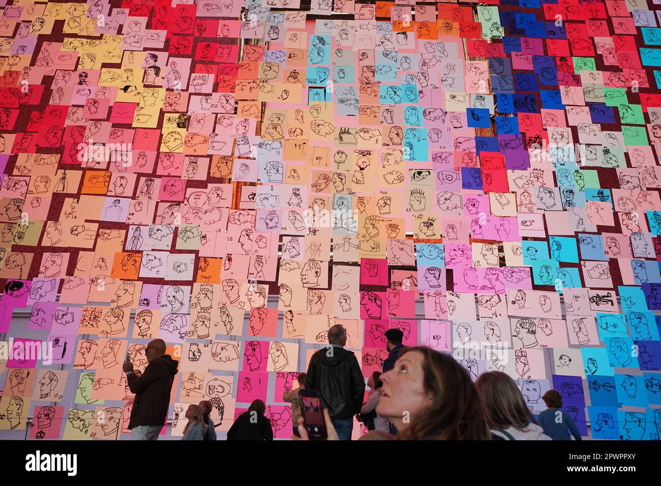 A digital portrait of King Charles III is unveiled on the screens at ...