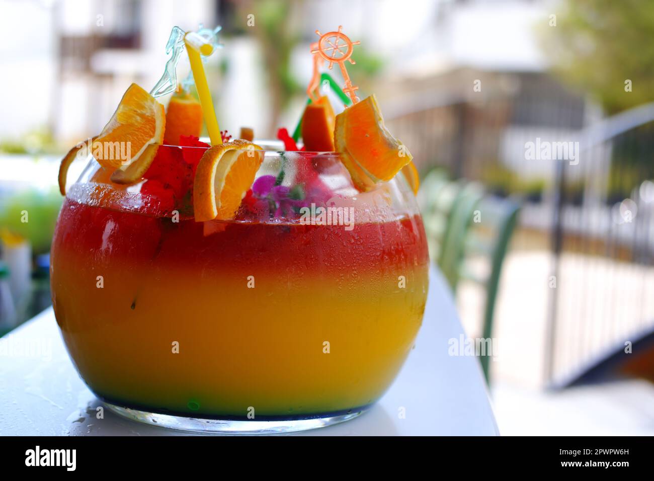 Big sphere glass for coctail outdoor on bar table in summer. Bokeh with ...