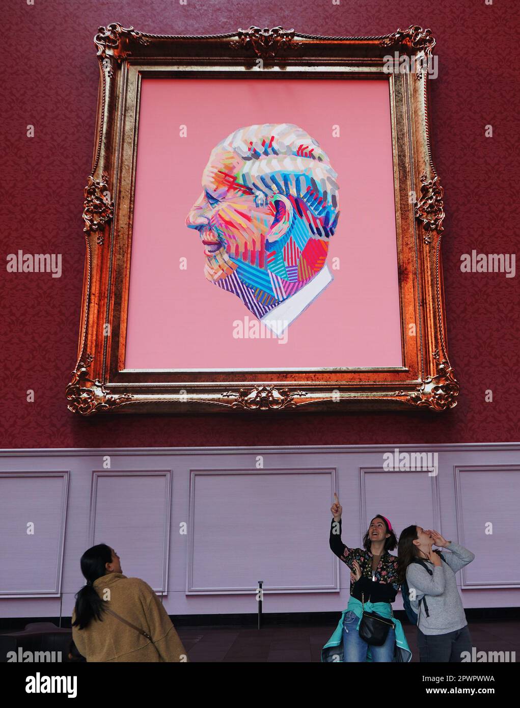 A digital portrait of King Charles III is unveiled on the screens at ...