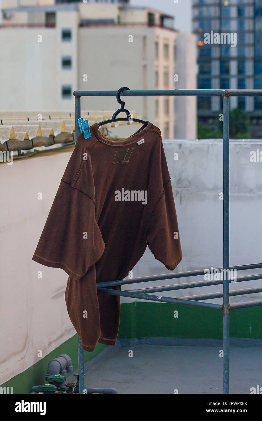 Wet coat hanging hi-res stock photography and images - Alamy