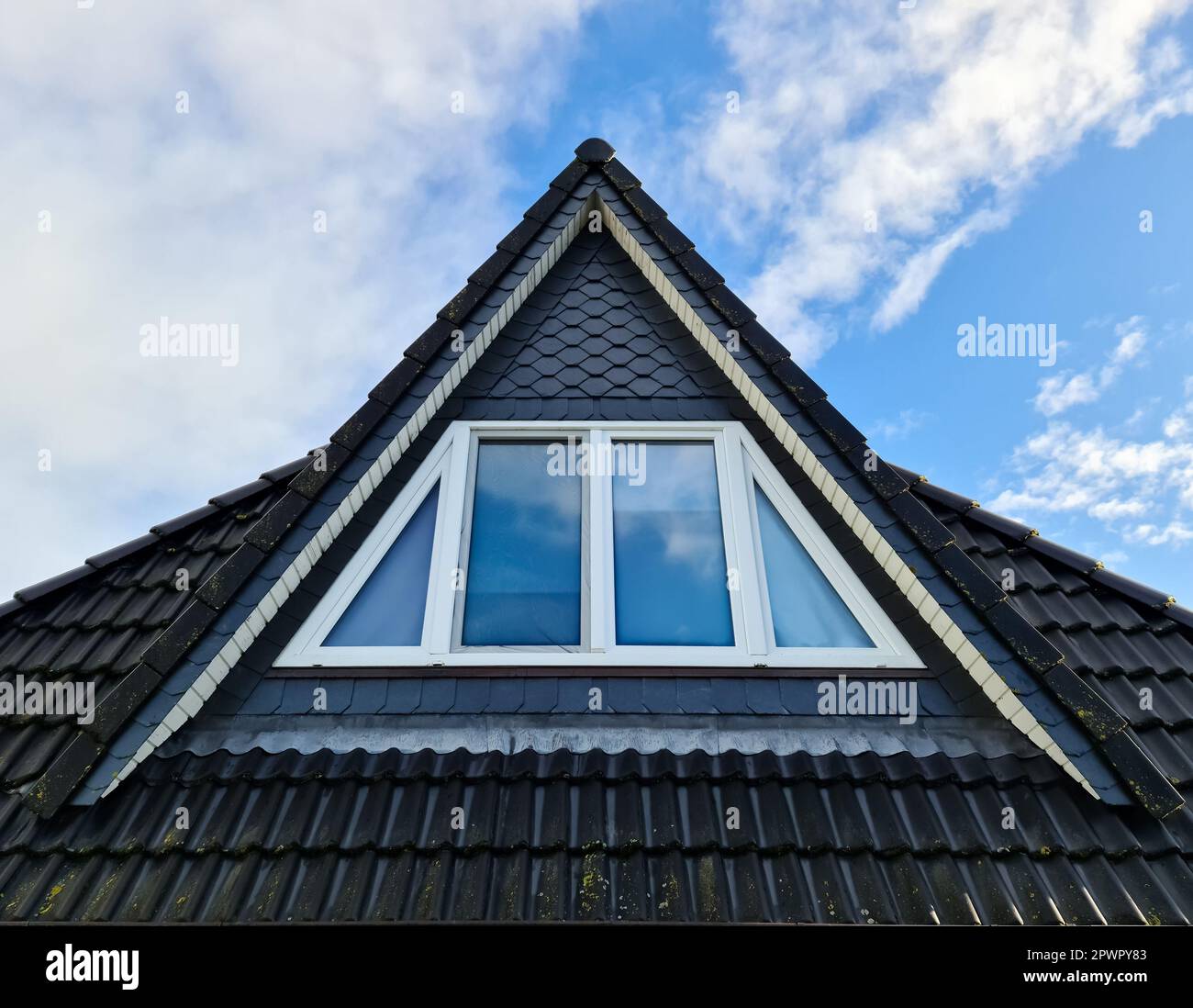 Open roof window in velux style with black roof tiles Stock Photo - Alamy