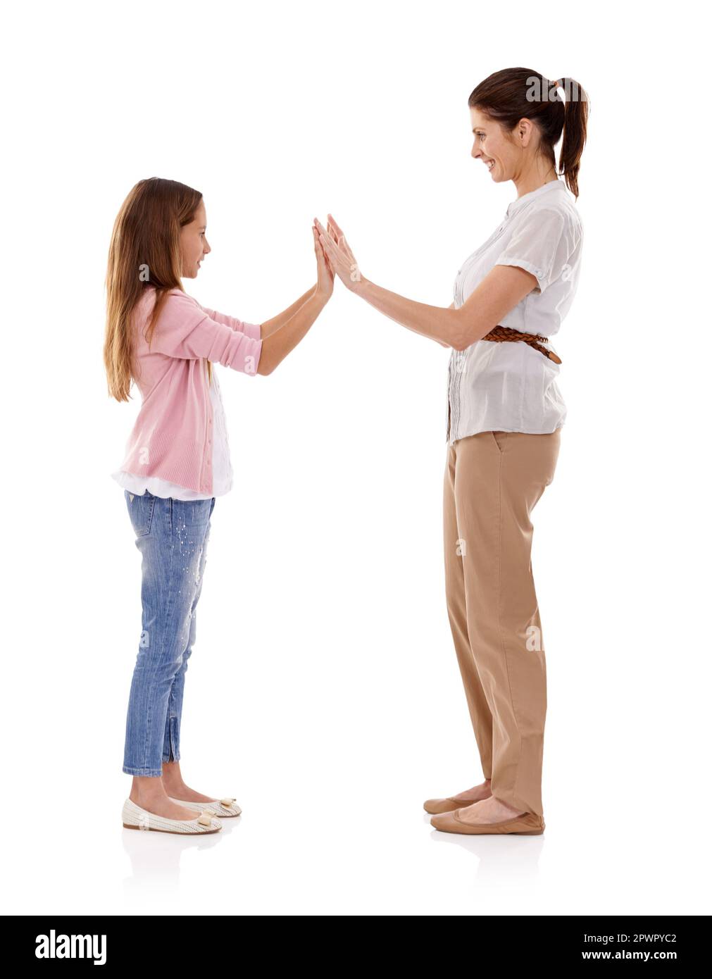 Fun and games with Mom. Side view of a mother and daughter being ...