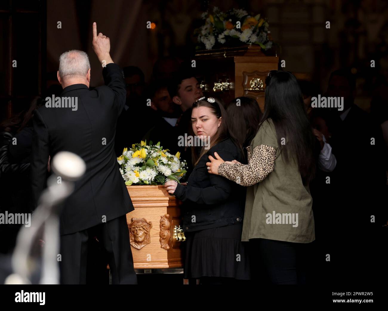 The coffins of Dan and Christine McKane, two of the three victims of ...
