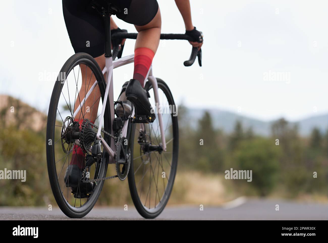 Male cyclist riding racing bicycle, man cycling on countryside summer ...