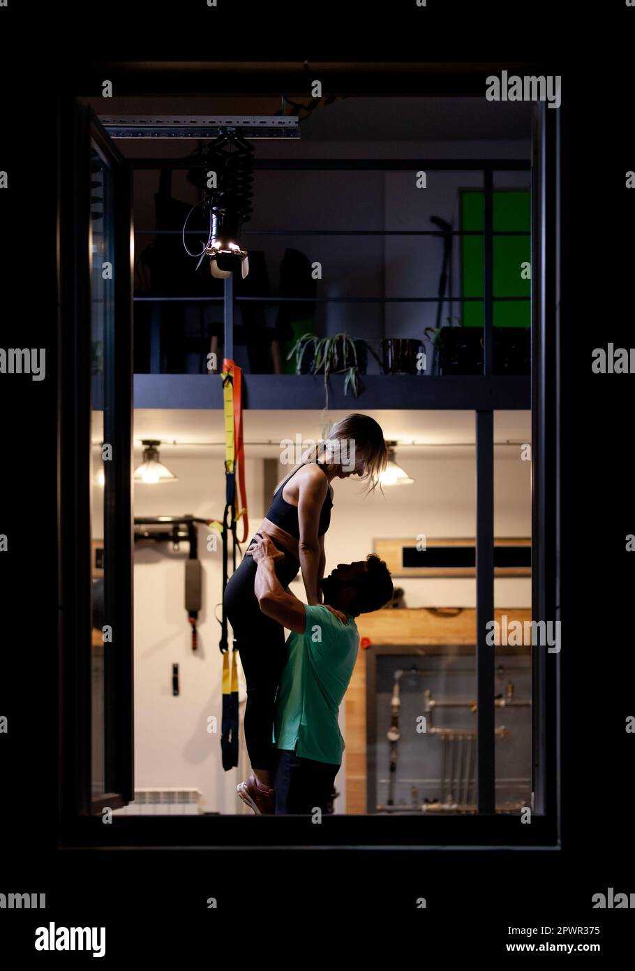 Couple in love. Boy and girl hugging in a fitness studio. View from ...
