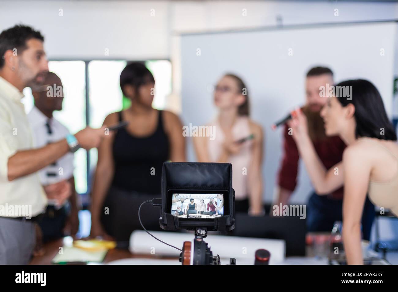 Professional camera recording multiracial business people having ...