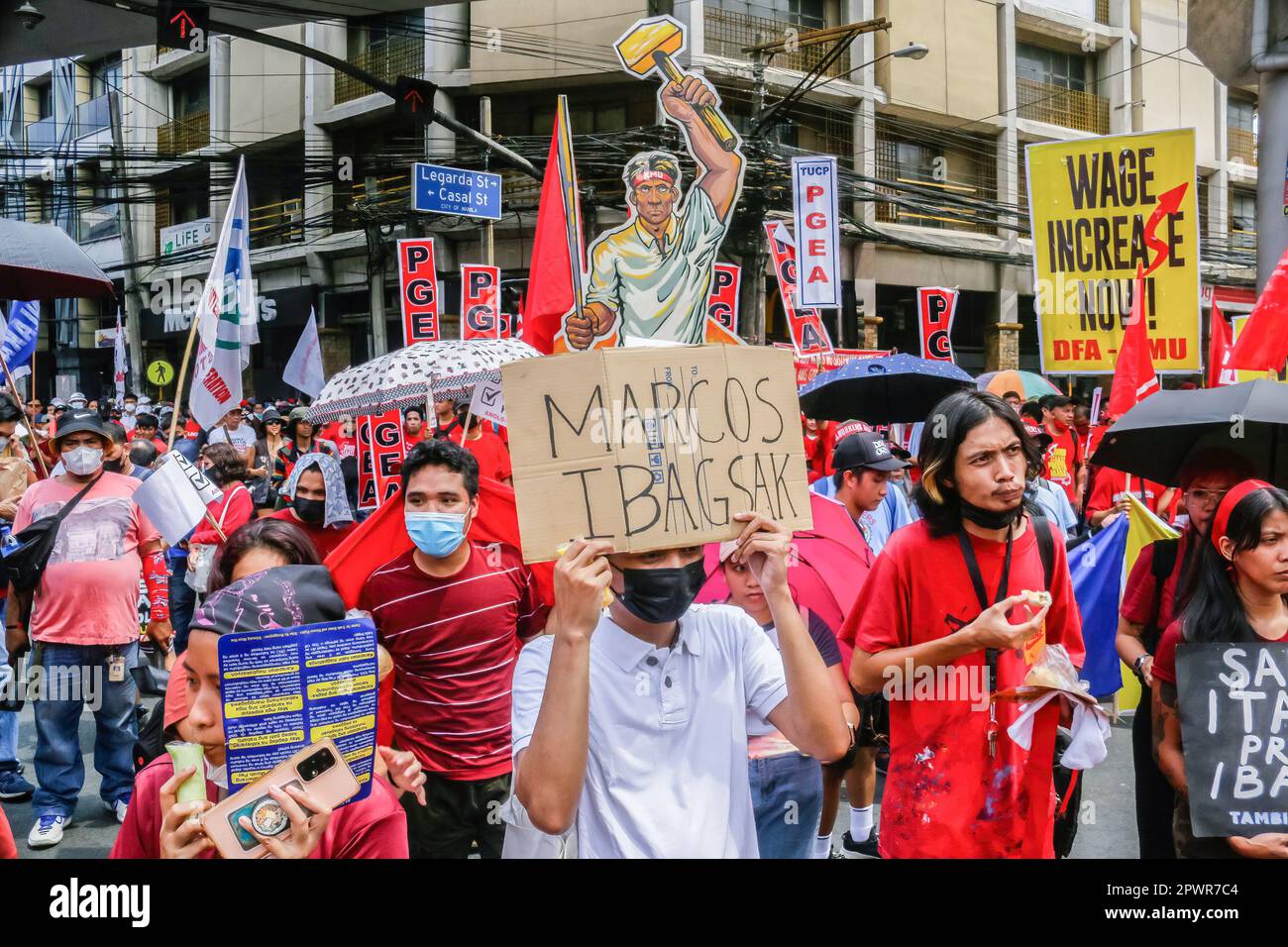 Union leaders, workers and activists hold signs expressing their ...