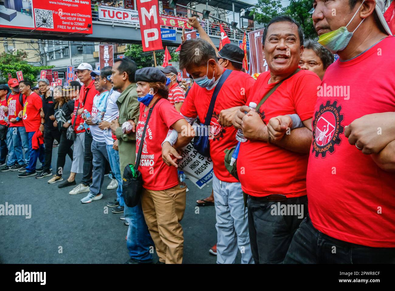 Union leaders, workers and activists march through the streets while ...
