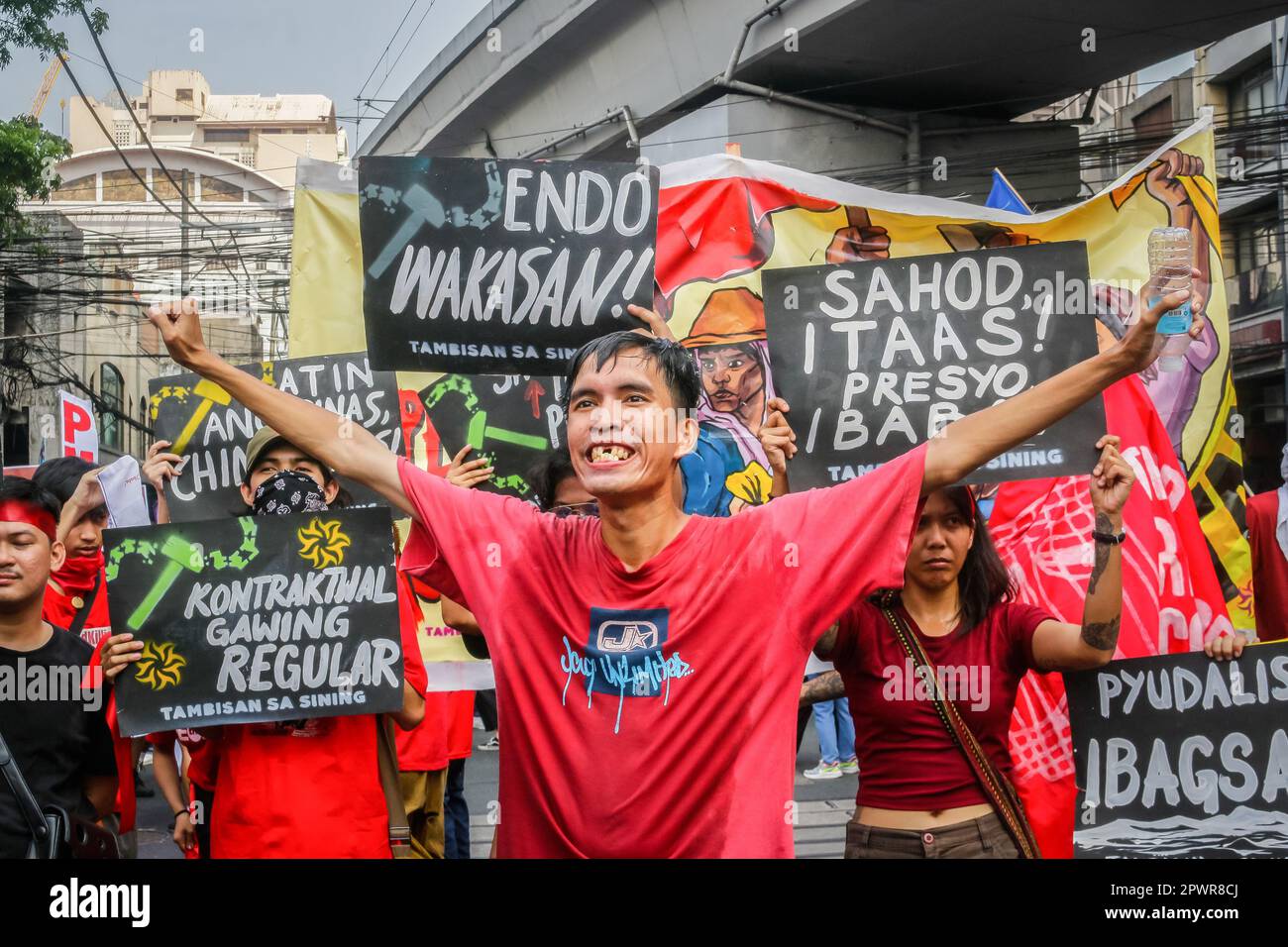 A man chants slogans during the protest on Labor Day in Manila. The ...