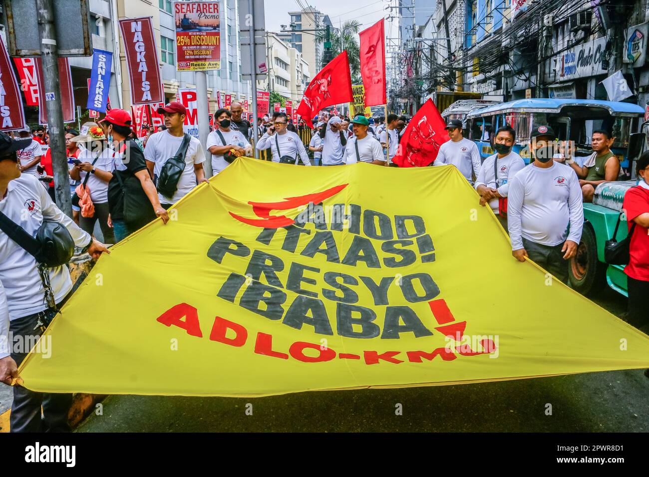 Union leaders, workers and activists march through the streets holding ...