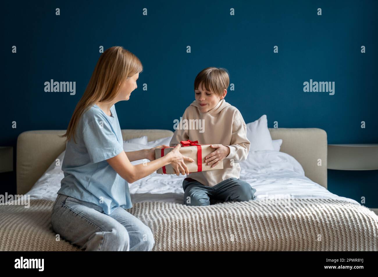 Excited overjoyed little boy child receiving unexpected birthday gift ...