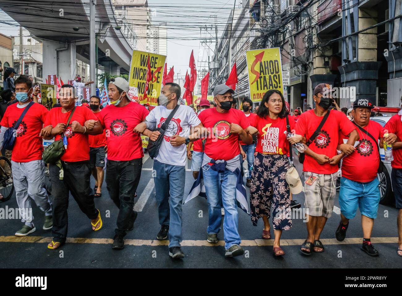 Union leaders, workers and activists march through the streets while ...