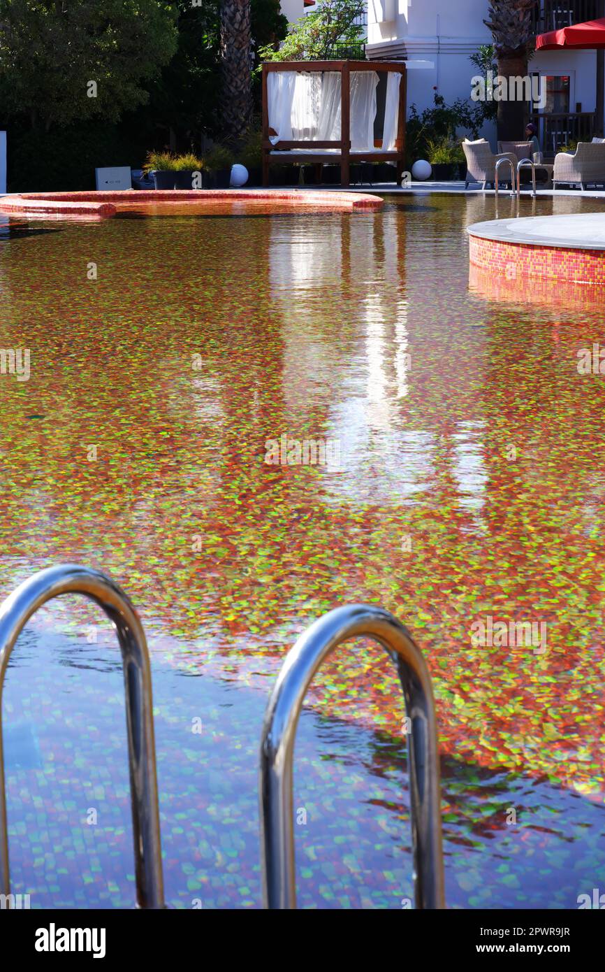 Empty hotel pool with chairs and tables poolside Stock Photo - Alamy