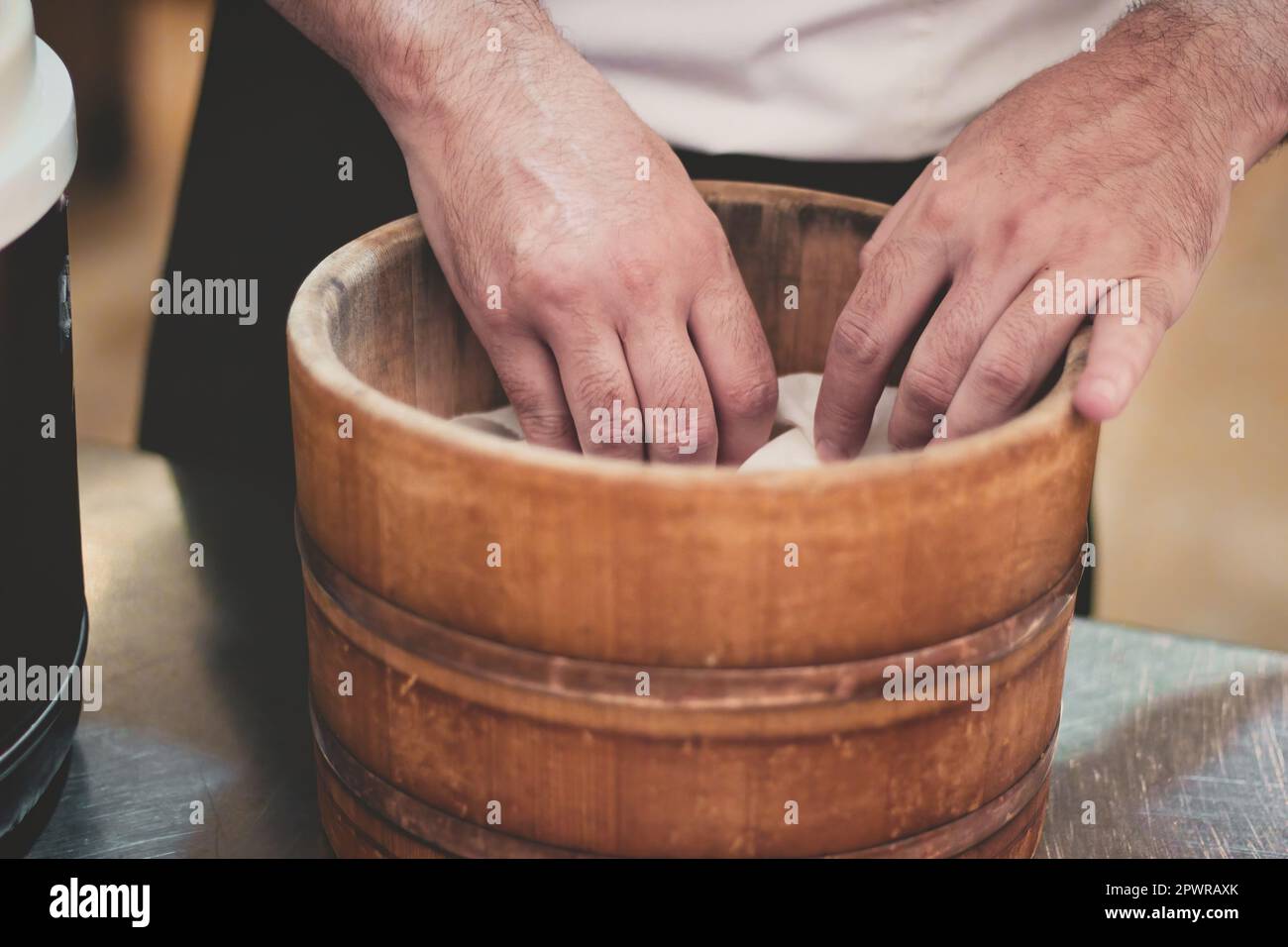 Close-up of hands of a unrecognizable sushi chef cooking rice in a ...