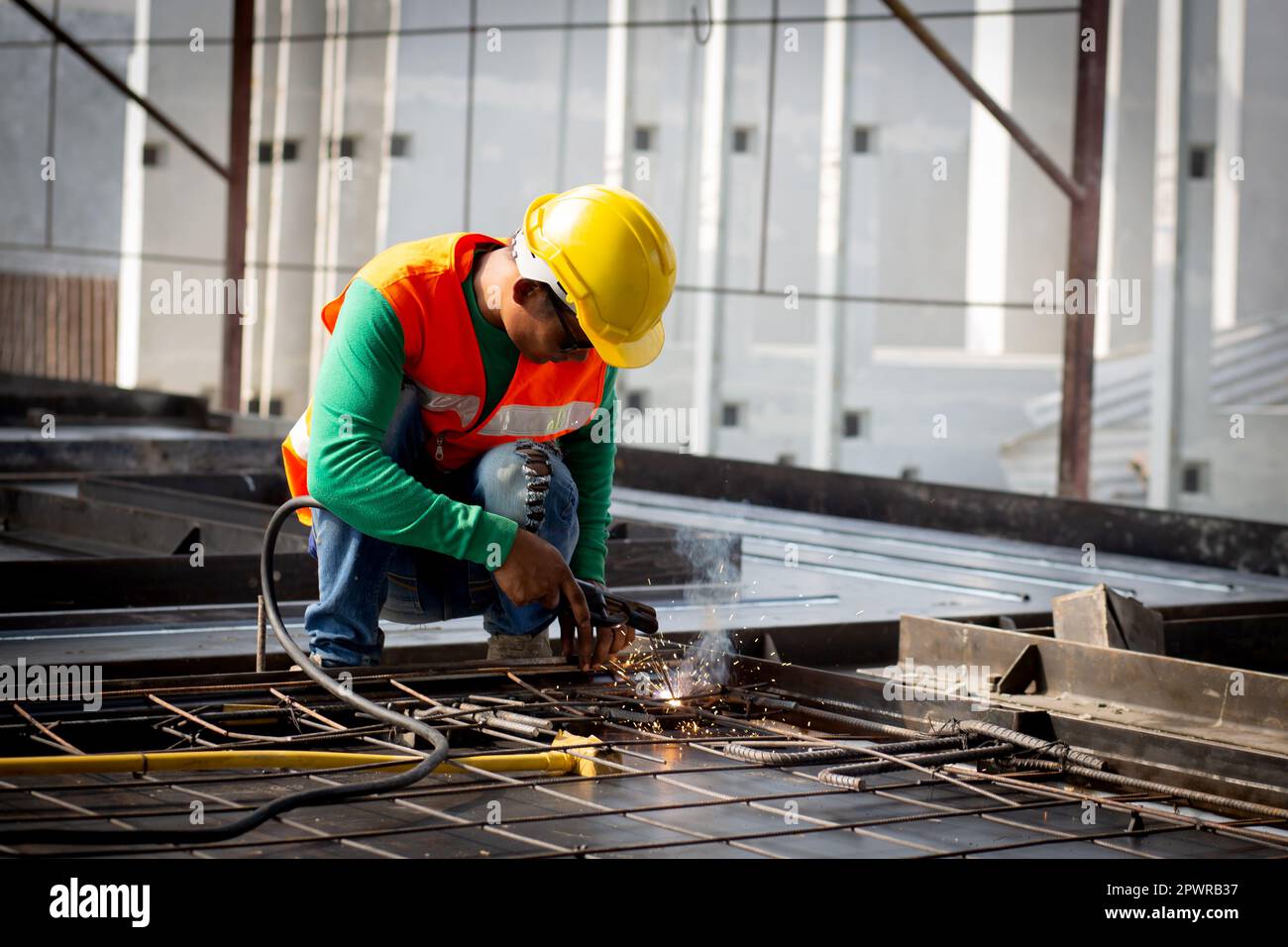 Young asian worker using machine welding iron with hands working in ...