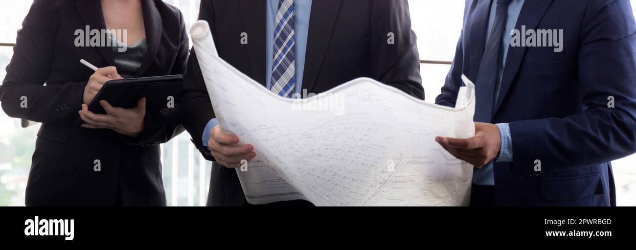 Senior architect and secretary inspector check blueprint and structure ...