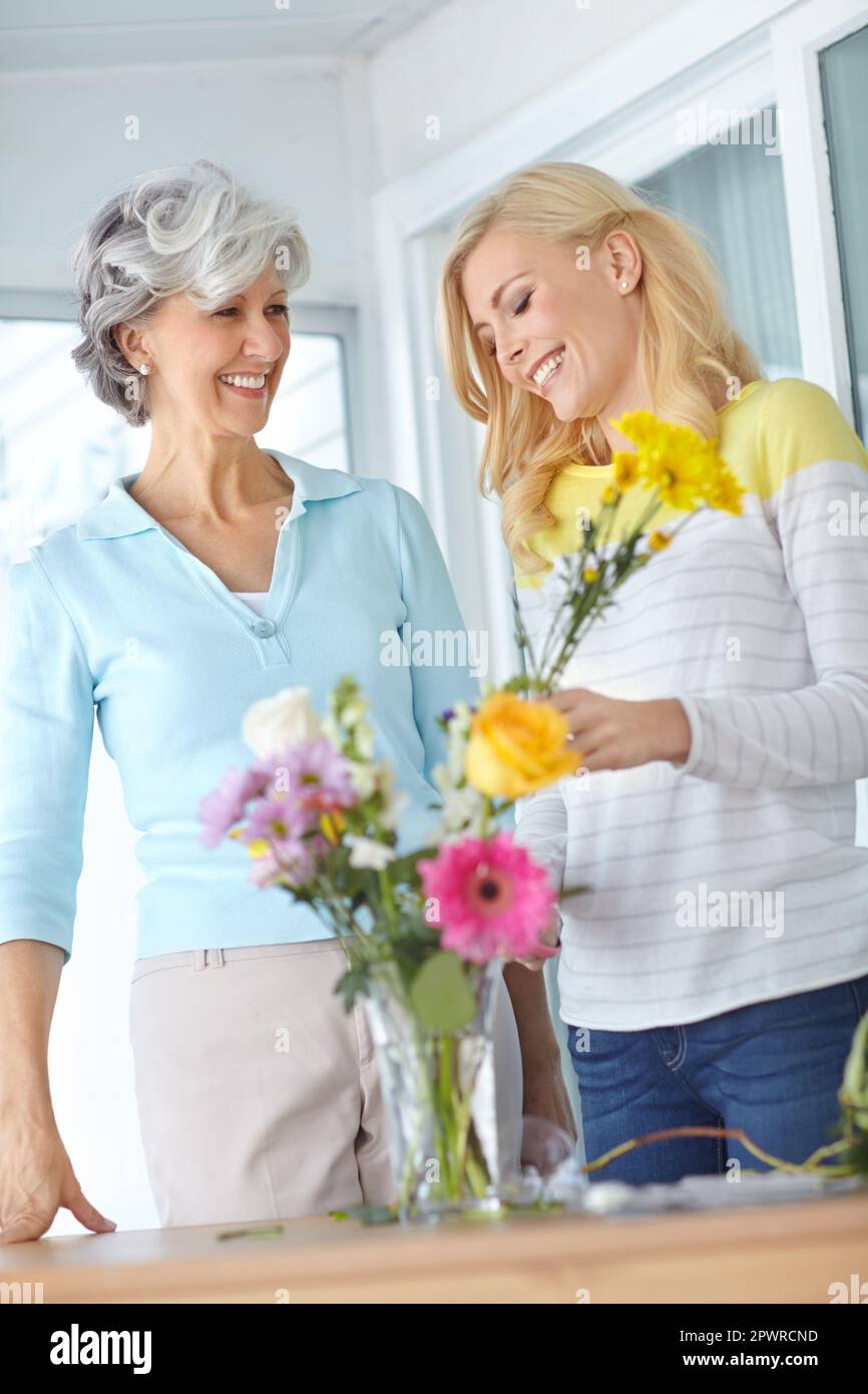 Getting some quality time with Mom. a senior woman enjoying some flower ...