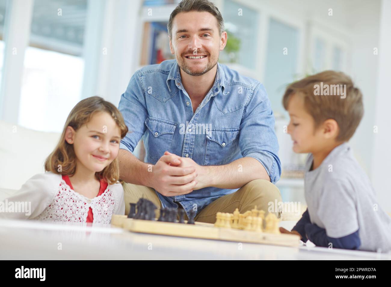 Chess with dad is the best. a father playing a game of chess with his ...