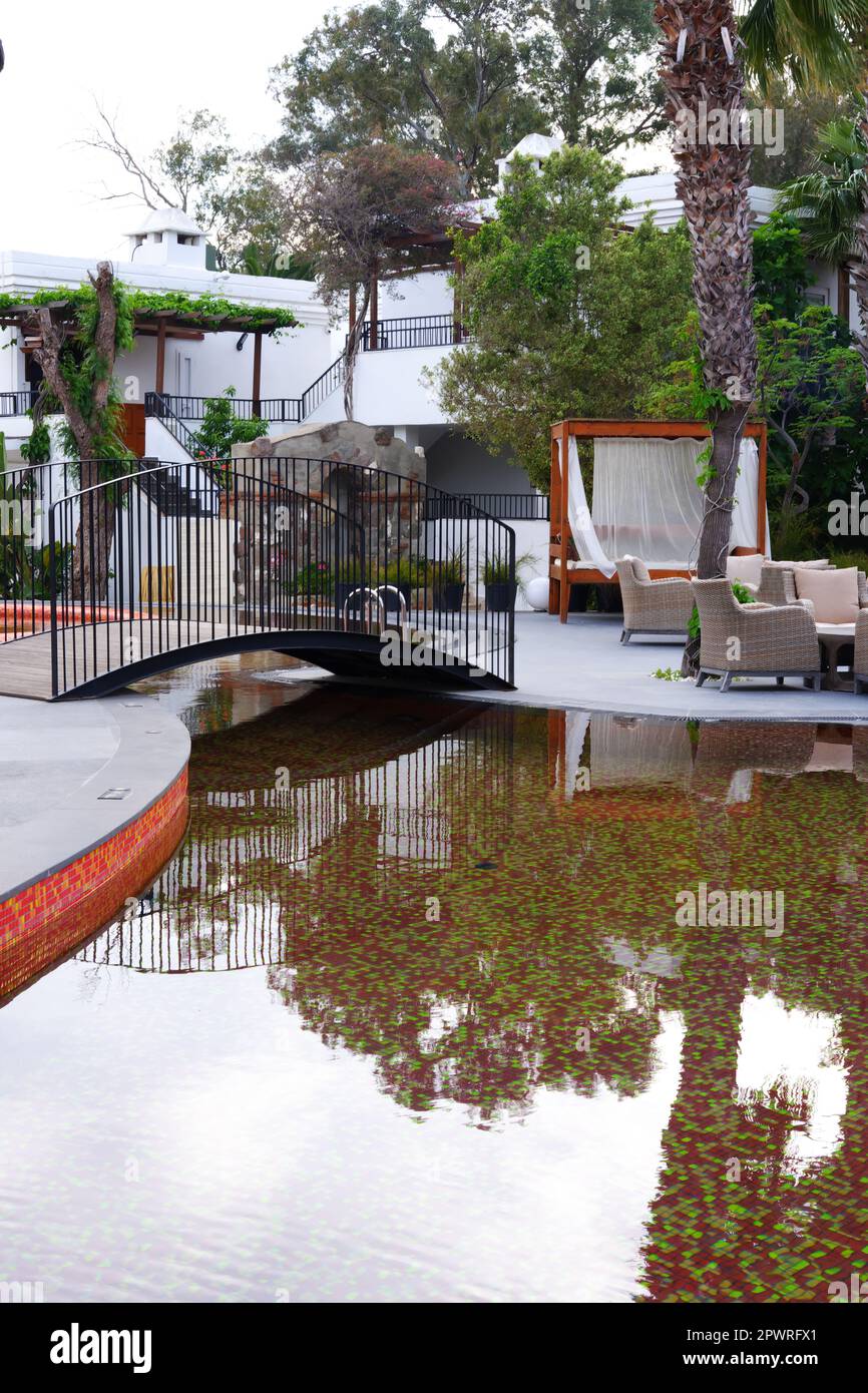Empty hotel pool with chairs and tables poolside Stock Photo - Alamy