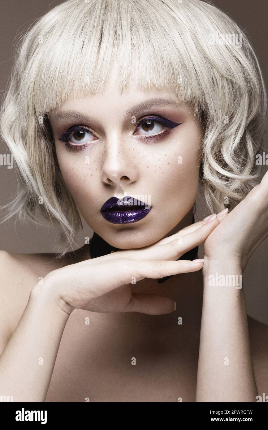 Beautiful woman with art makeup and a fashionable hair. The beauty of ...