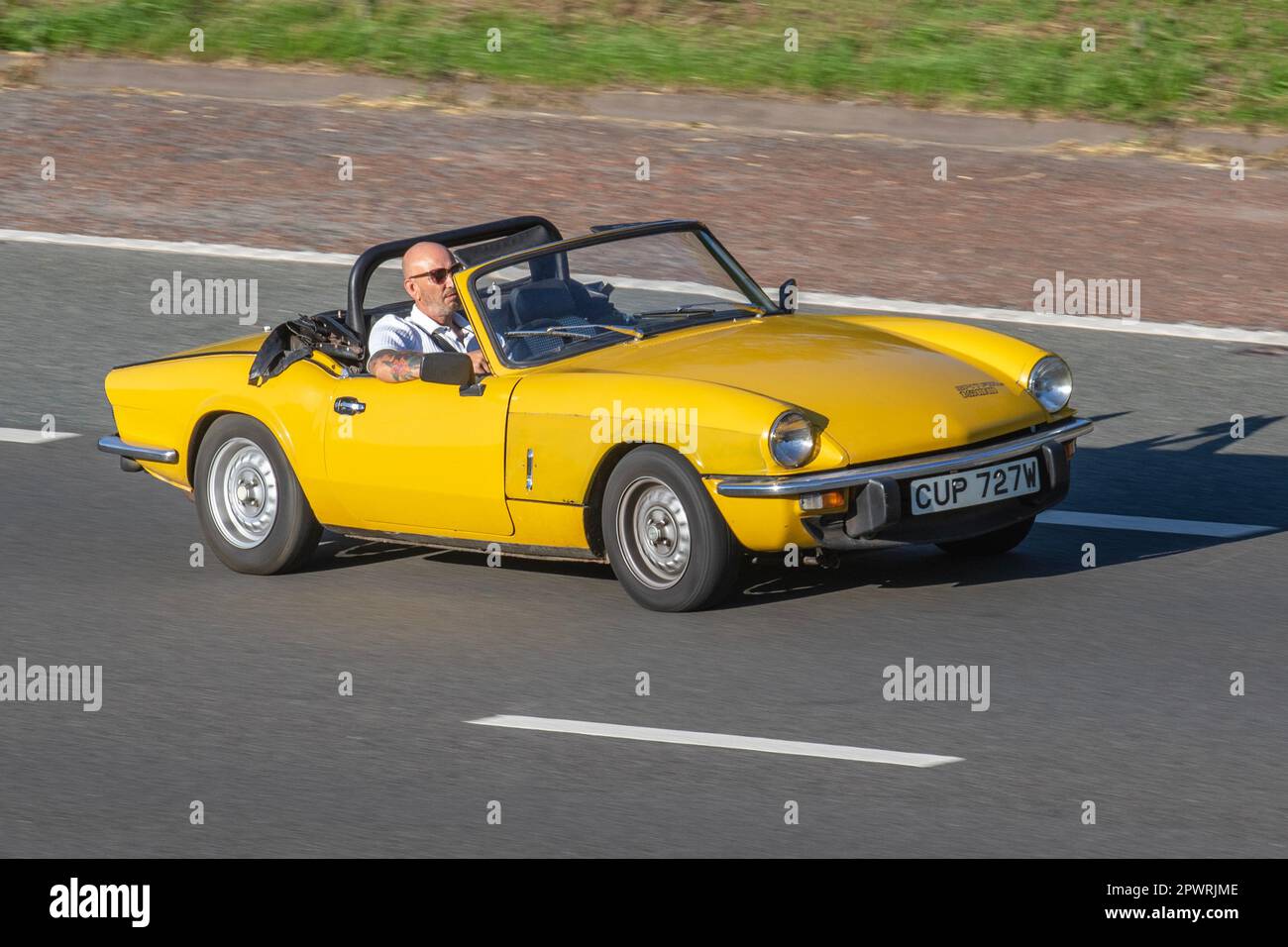 1980 80s eighties Yellow TRIUMPH SPITFIRE British sports car travelling ...