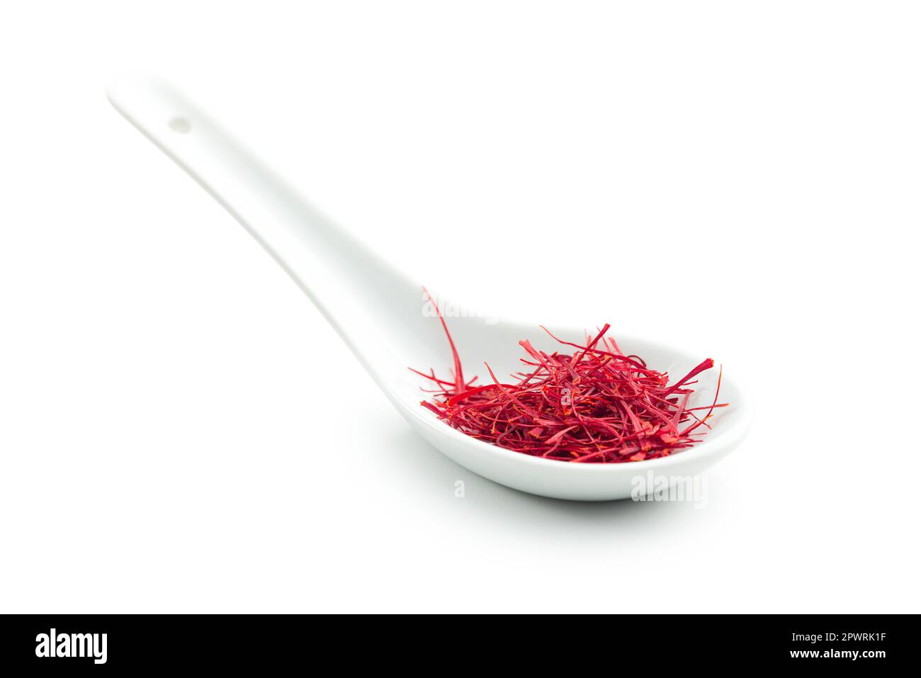 Dried saffron spice in spoon isolated on the white background Stock ...