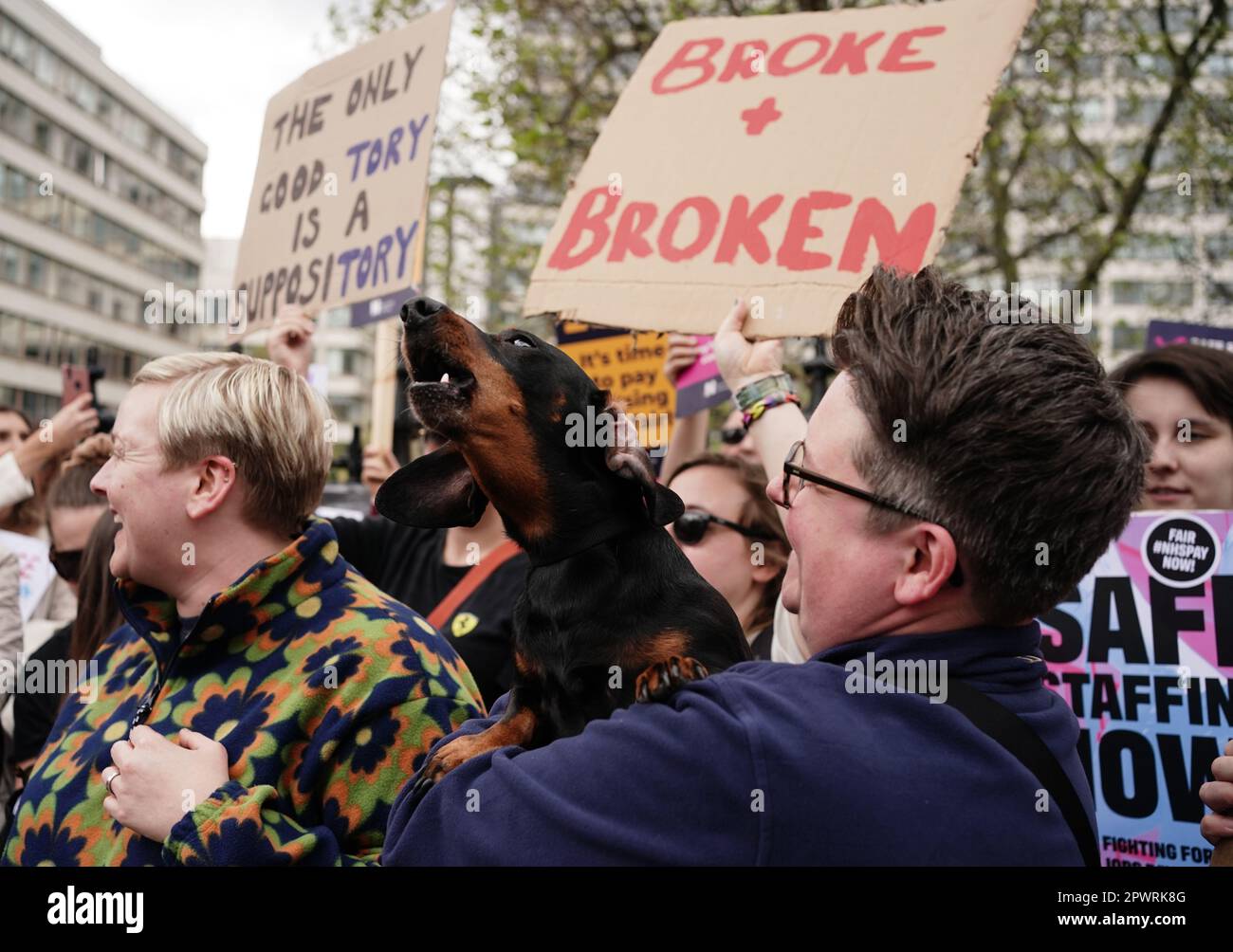 NHS workers with their dog on the picket line outside St Thomas ...