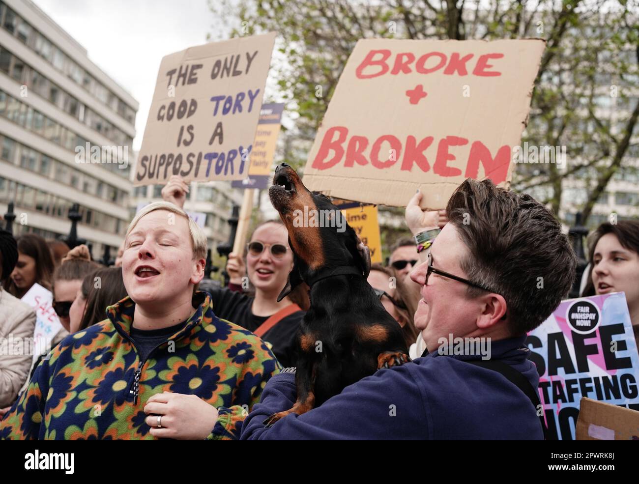 NHS workers with their dog on the picket line outside St Thomas ...