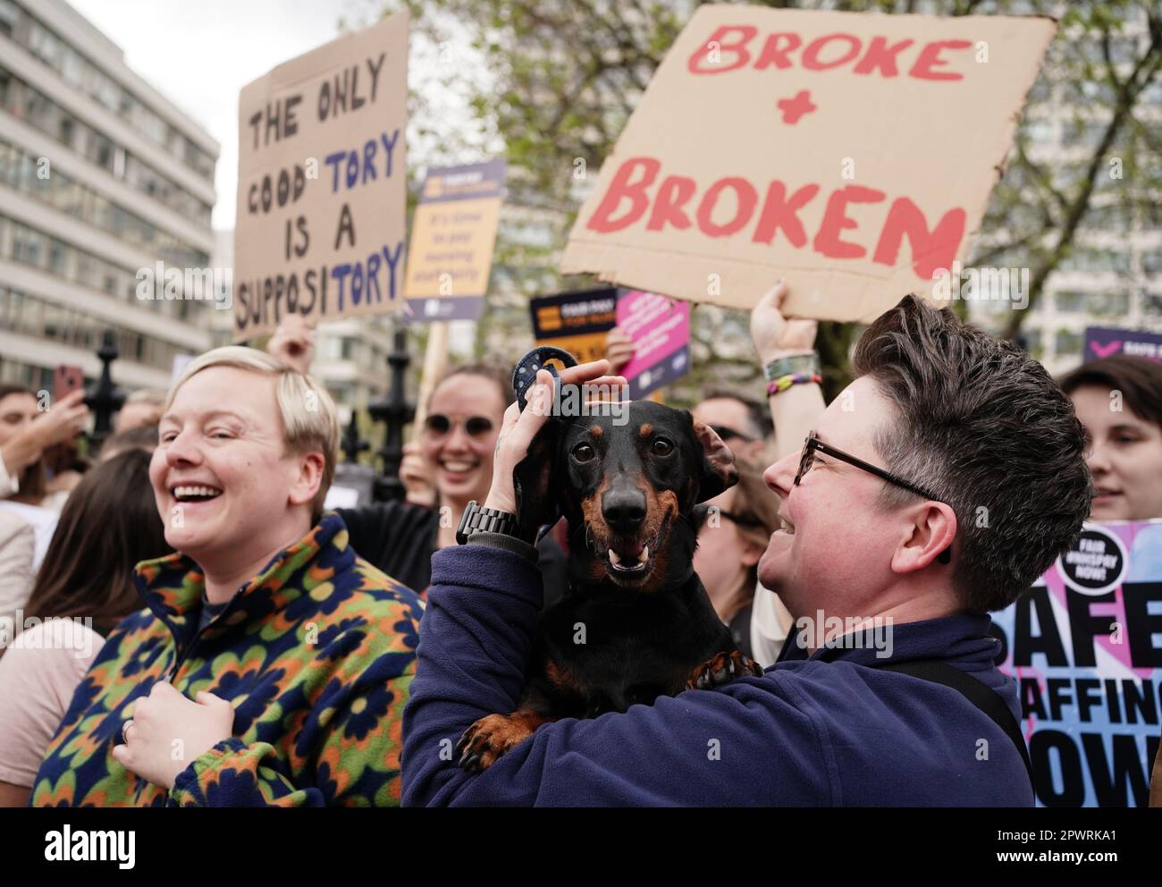 NHS workers with their dog on the picket line outside St Thomas ...