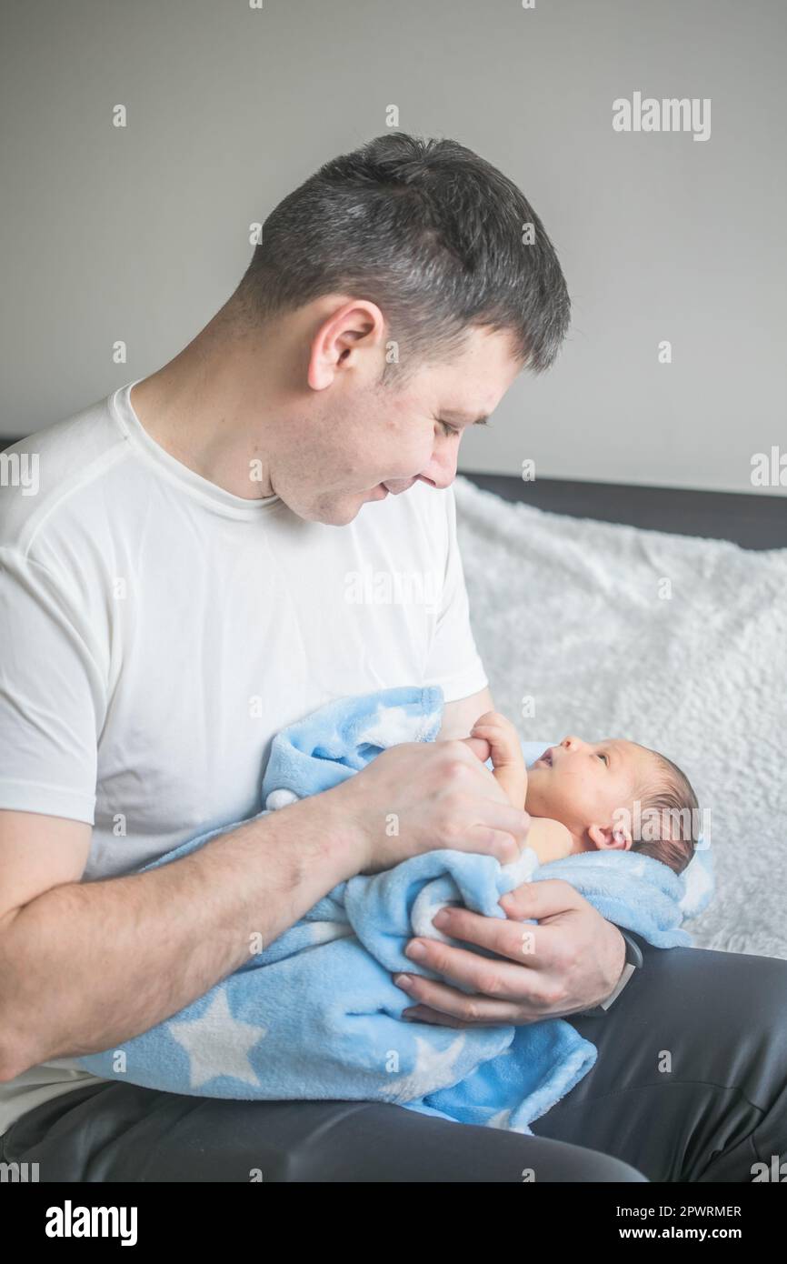 Father with his son, tiny infant. Newborn baby smiling, laughing and ...