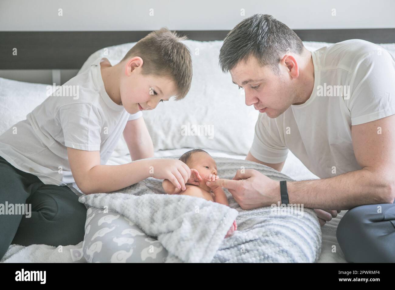 Portrait of father and his four son holding his newborn baby Stock ...