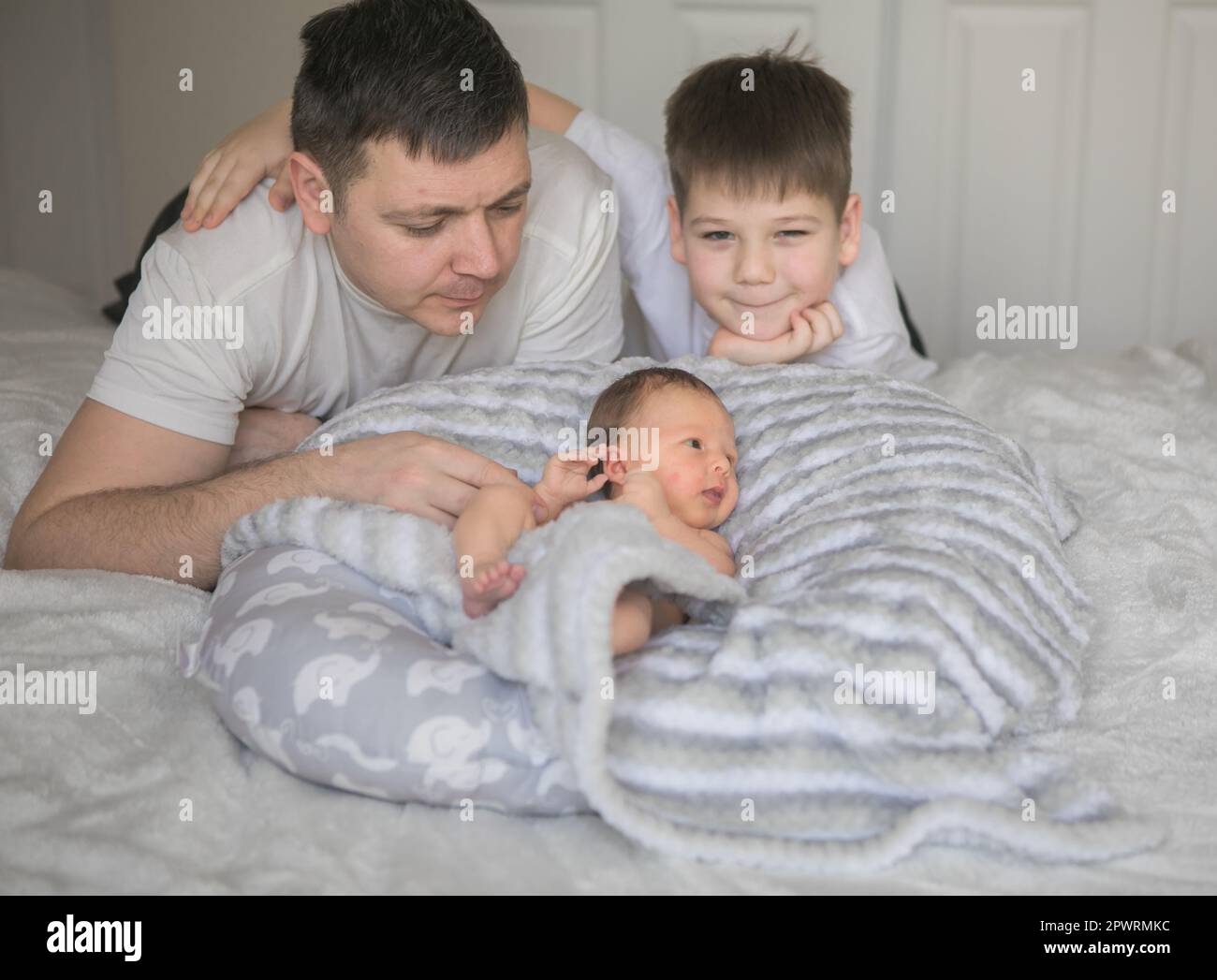 Portrait of father and his four son holding his newborn baby Stock ...